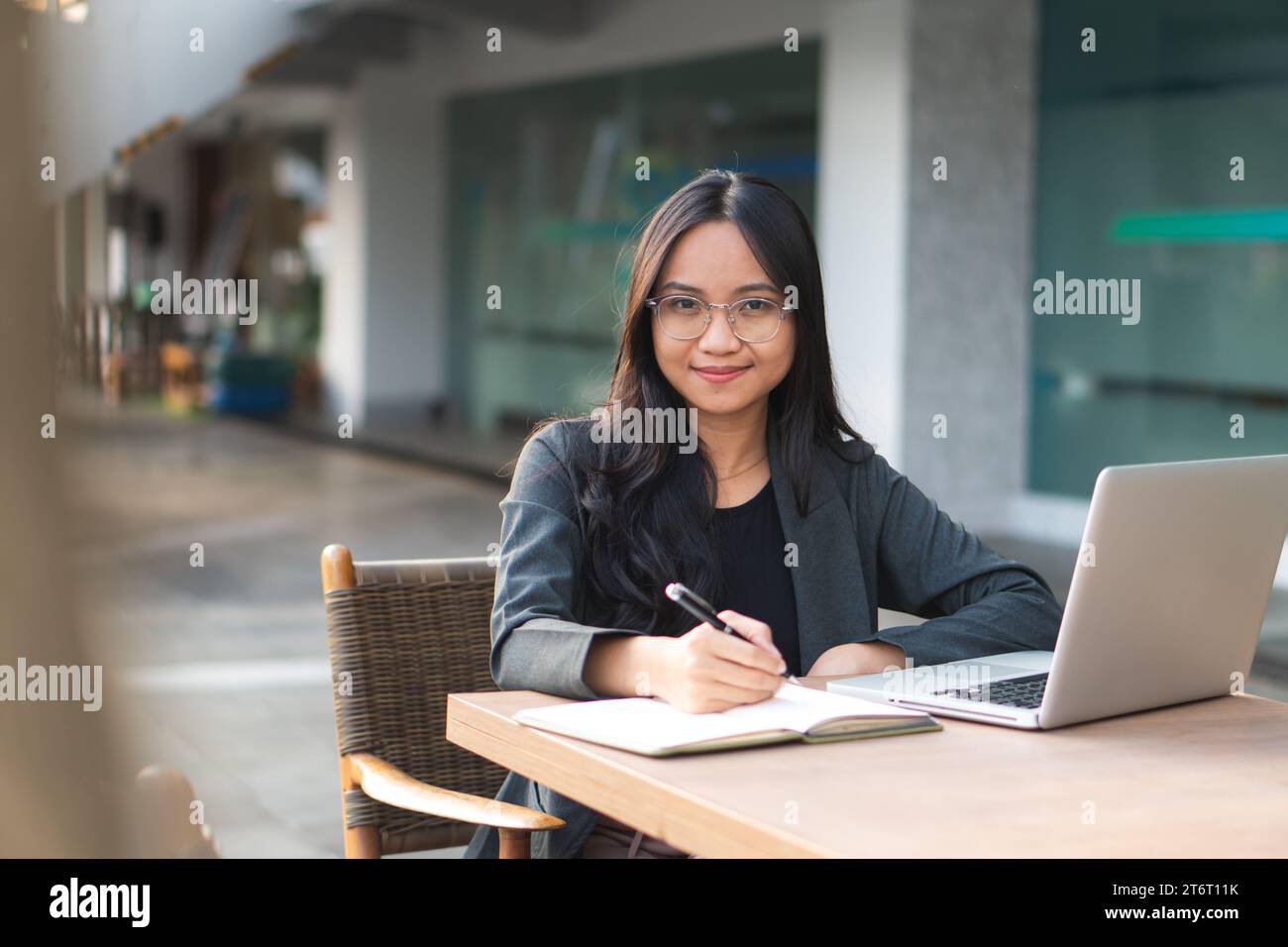 Asian woman happily writing hi-res stock photography and images - Alamy