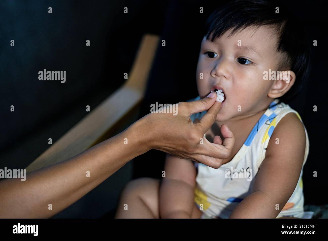 Mother Feeding Her Son With Rice. Mother Is Feeding Her Son. Concept of ...