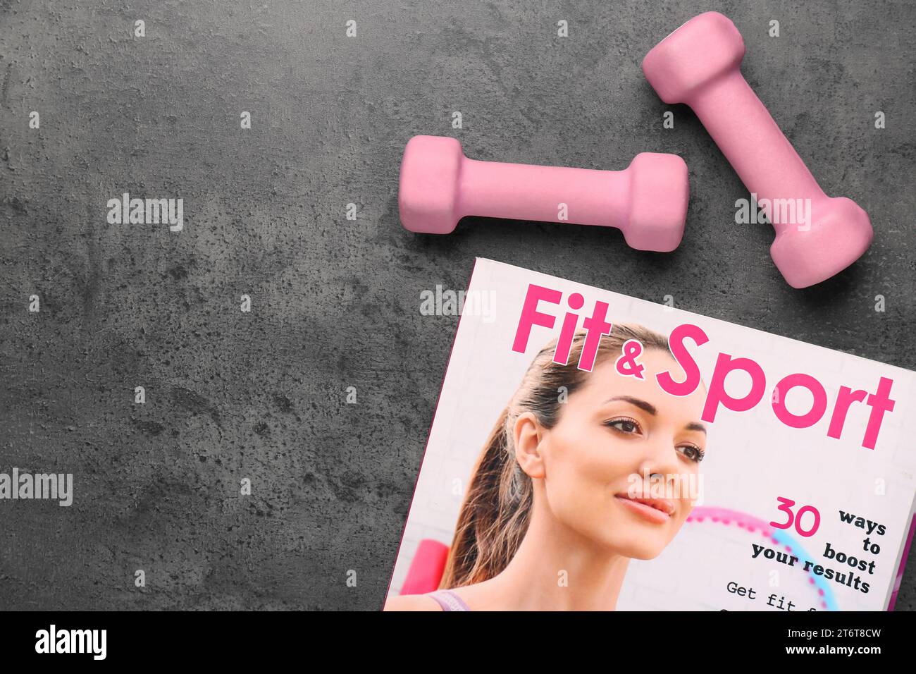 Dumbbells and magazine on brown textured table, flat lay. Space for ...