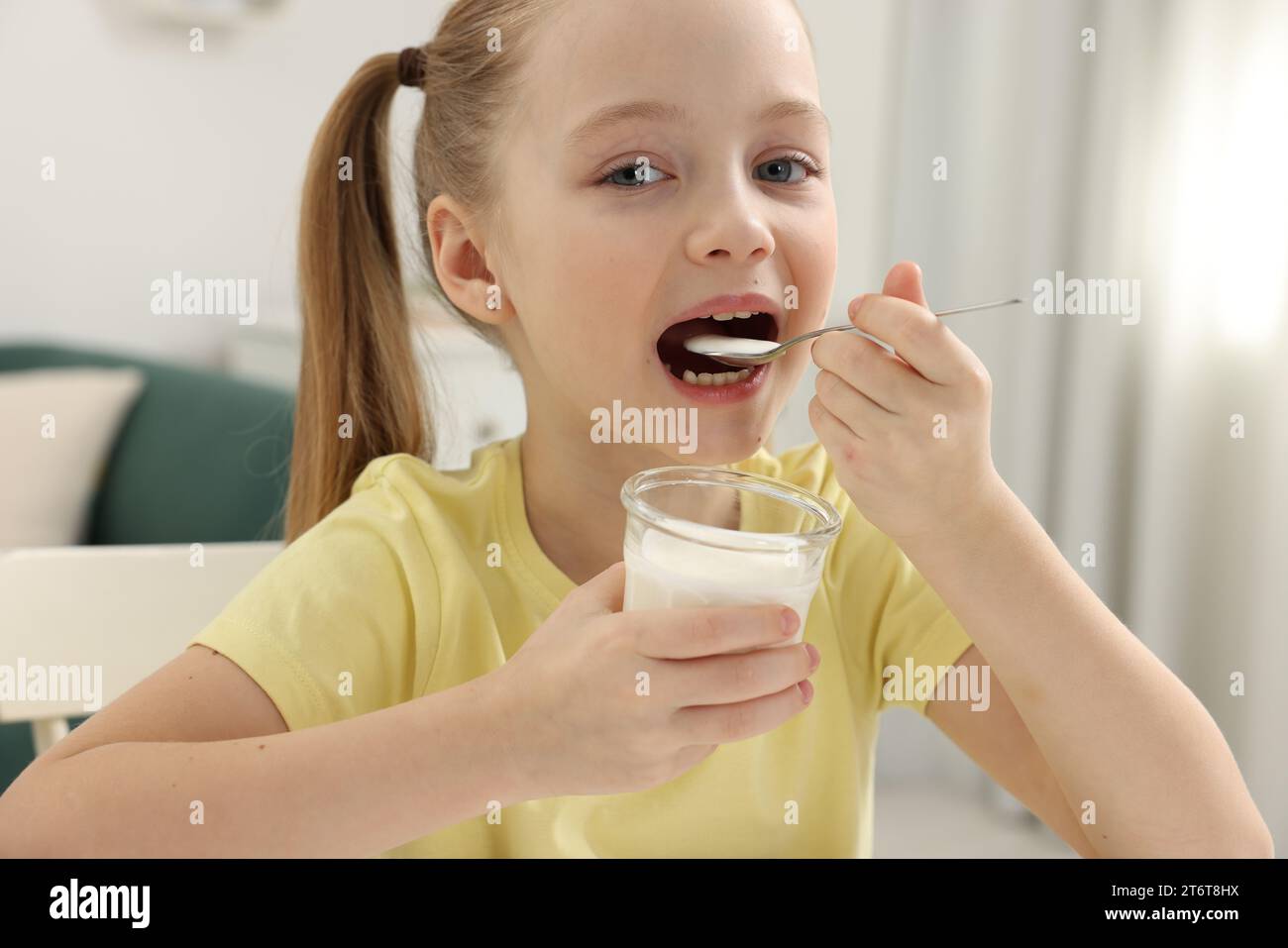 Child eating yogurt primary hi-res stock photography and images - Alamy