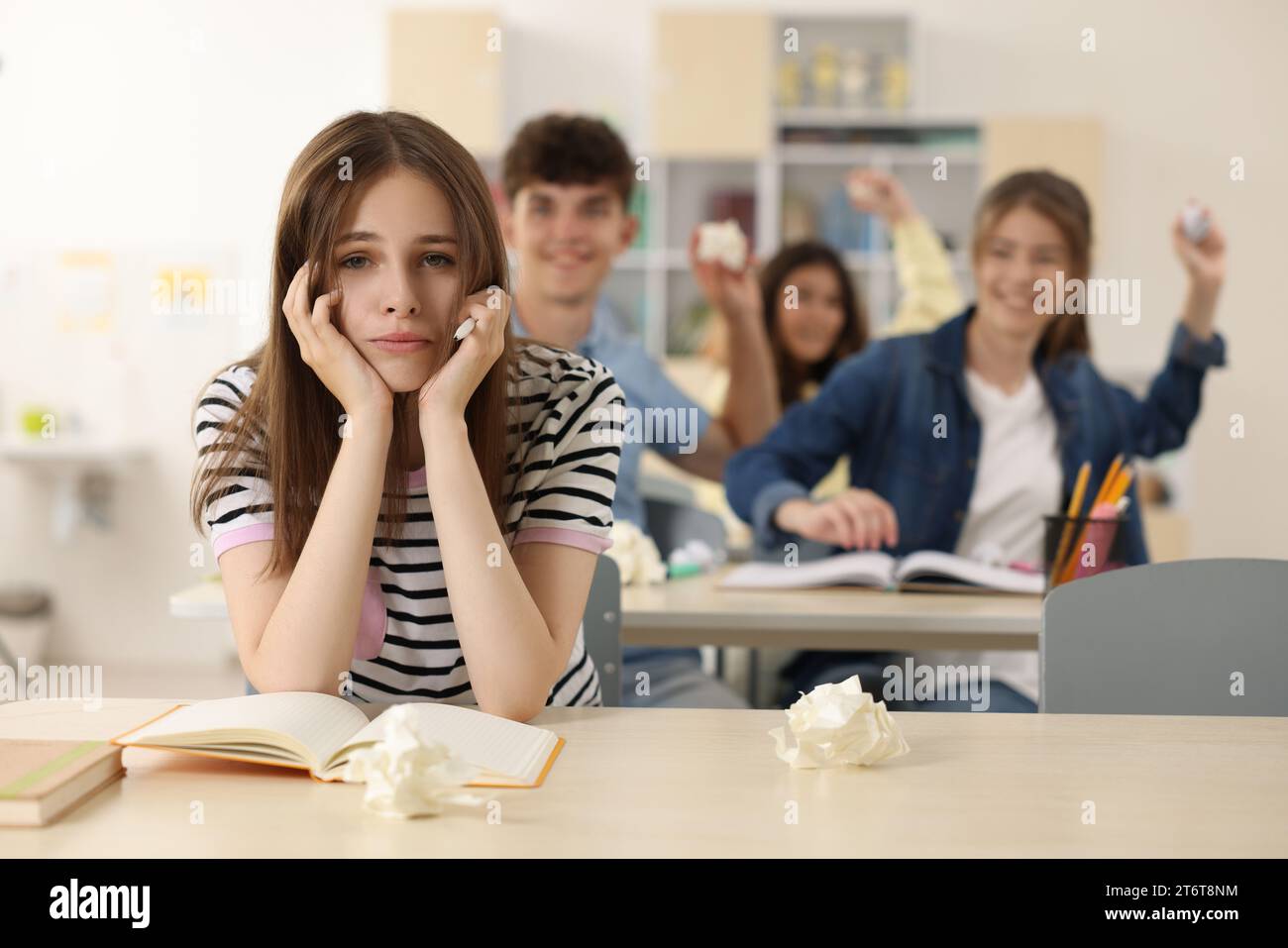 Teen problems. Students bullying their classmate in classroom ...