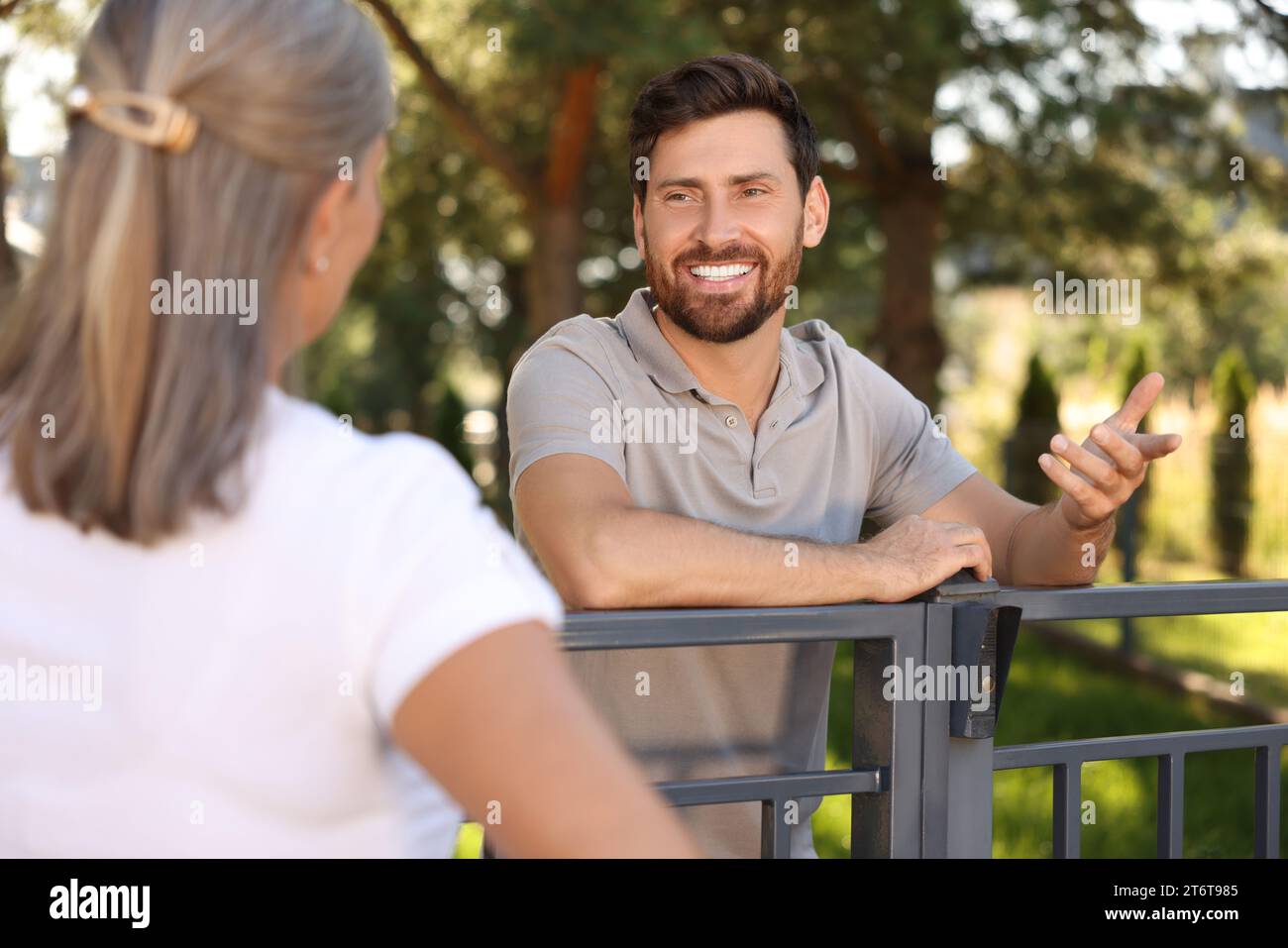 Friendly relationship with neighbours. Happy man and senior woman near ...