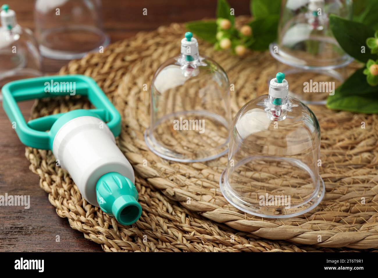 Cupping therapy. Plastic cups and hand pump on table, closeup Stock ...