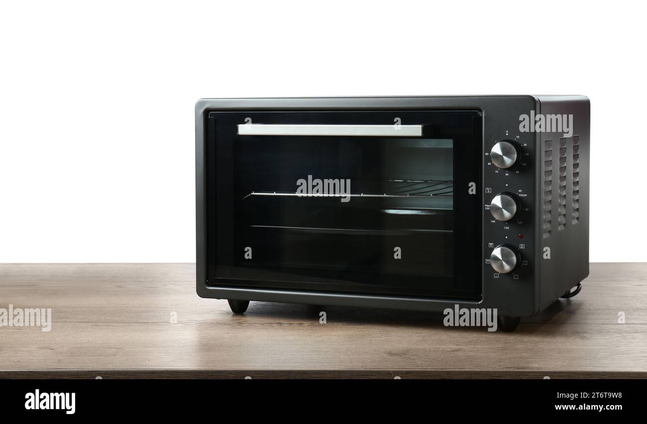 One electric oven on wooden table against white background Stock Photo ...