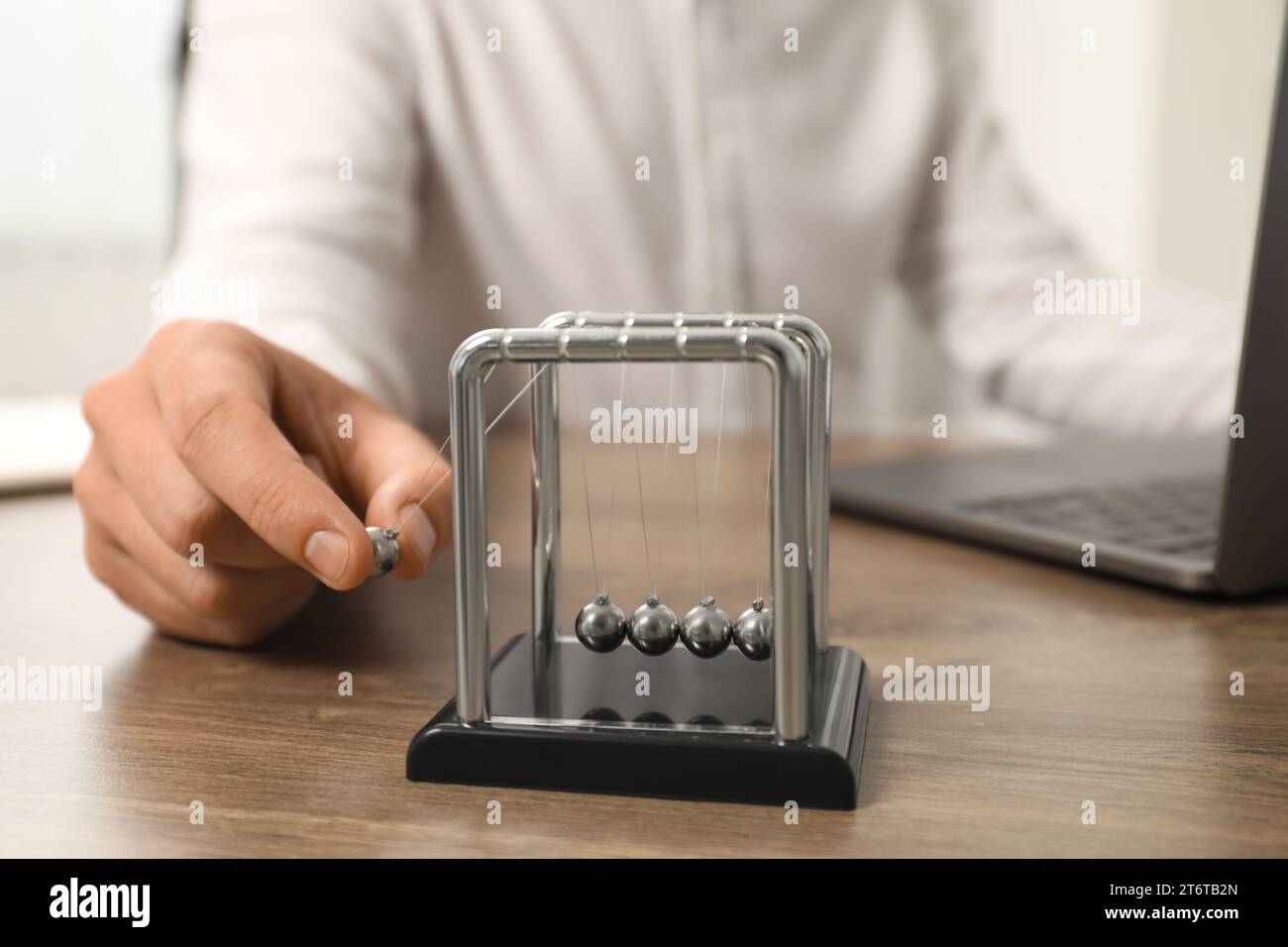 Newton's cradle and hand hi-res stock photography and images - Alamy