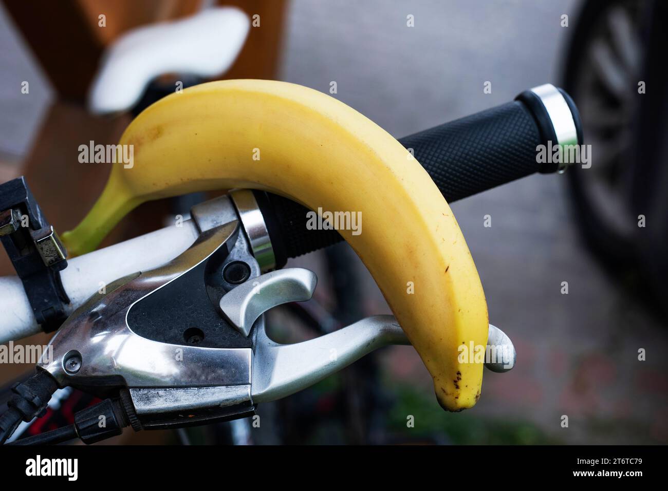 ripe yellow banana on the handlebars of a bicycle. Workout and proper ...