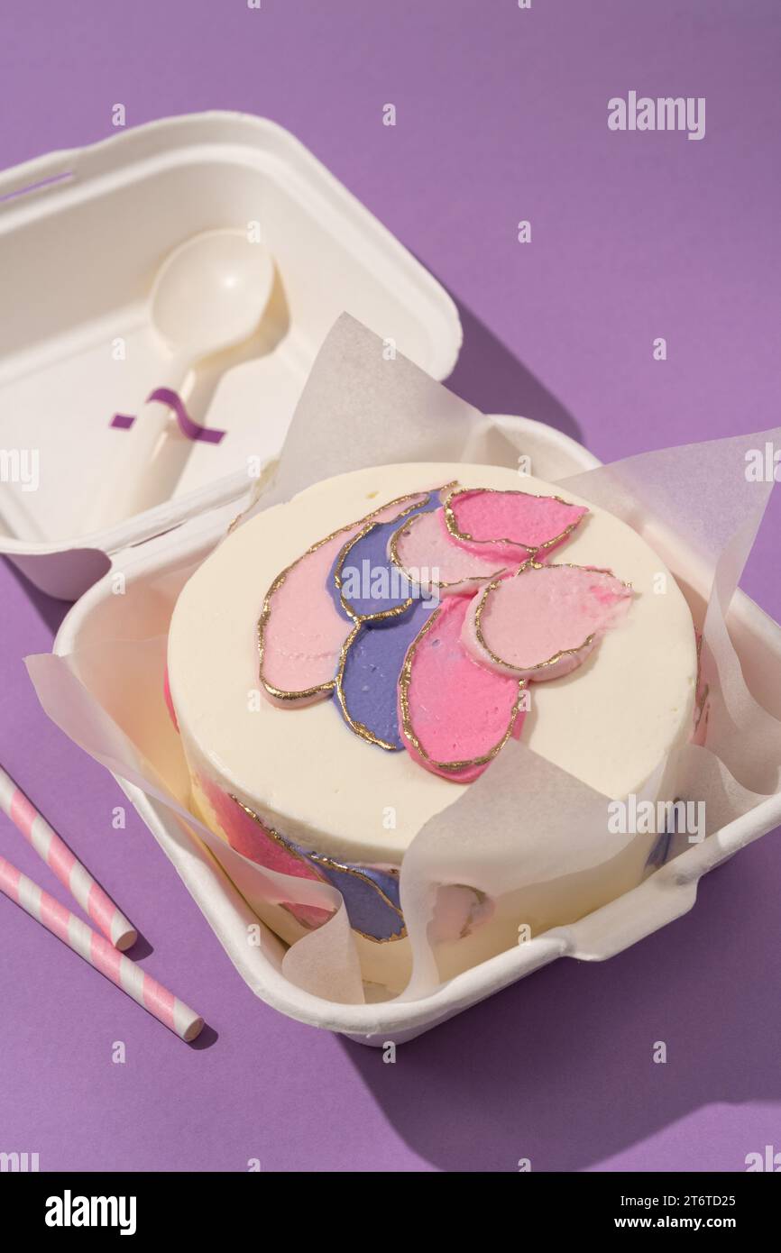 Small bento cake In box on purple background Stock Photo - Alamy