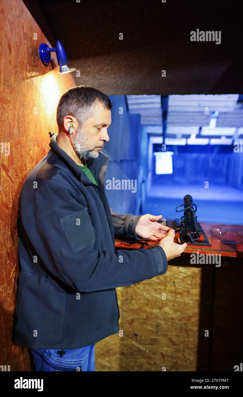 Man with pistol at firing range Stock Photo - Alamy