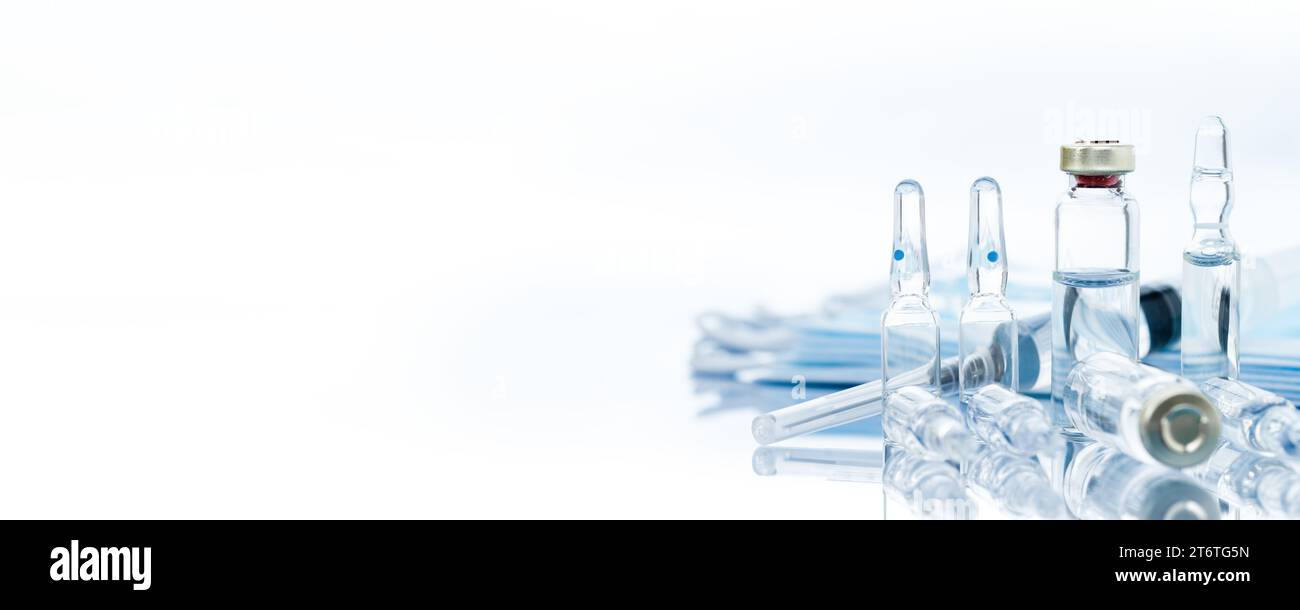 Medical vials for injection with a syringe and ampules on a light ...