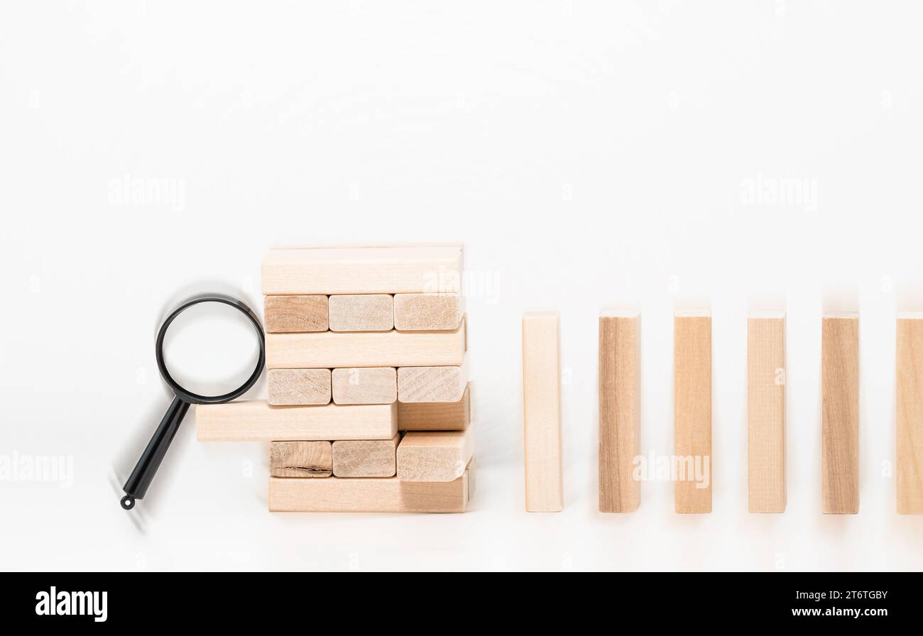 Business risk control concept, Magnifying glass protect wooden block ... Business risk control concept, Magnifying glass protect wooden block ...