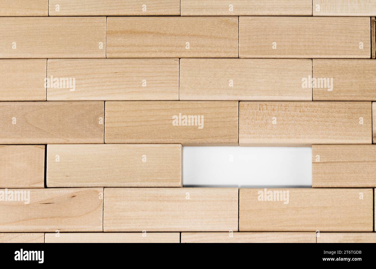 Wooden blocks are stacked one after another with the missing element ...