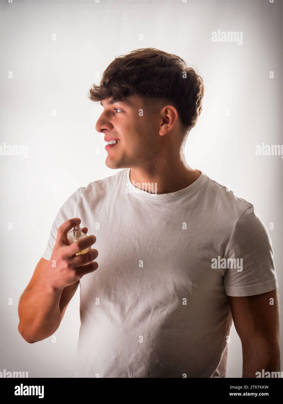 Handsome man spraying bottle hi-res stock photography and images - Alamy