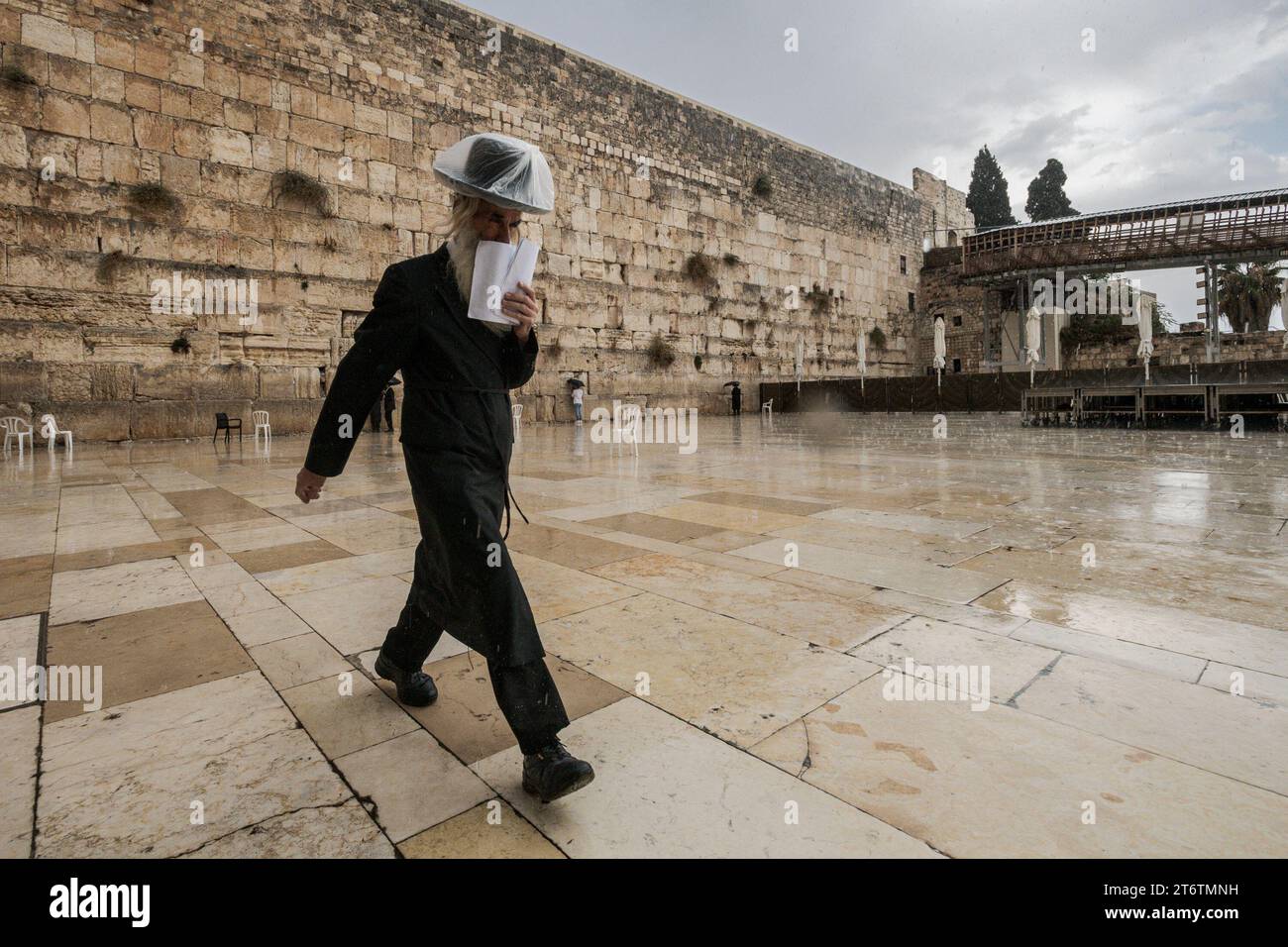 A man of the Jewish religion walking in the plaza of the Western Wall ...