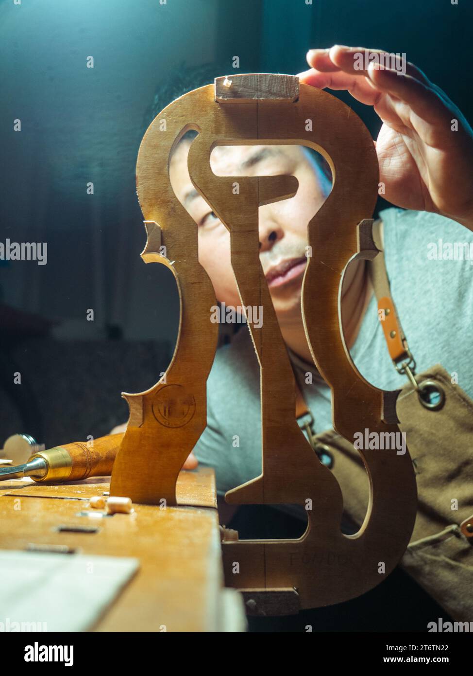 luthier violin maker luthier working with violin mould on top block ...