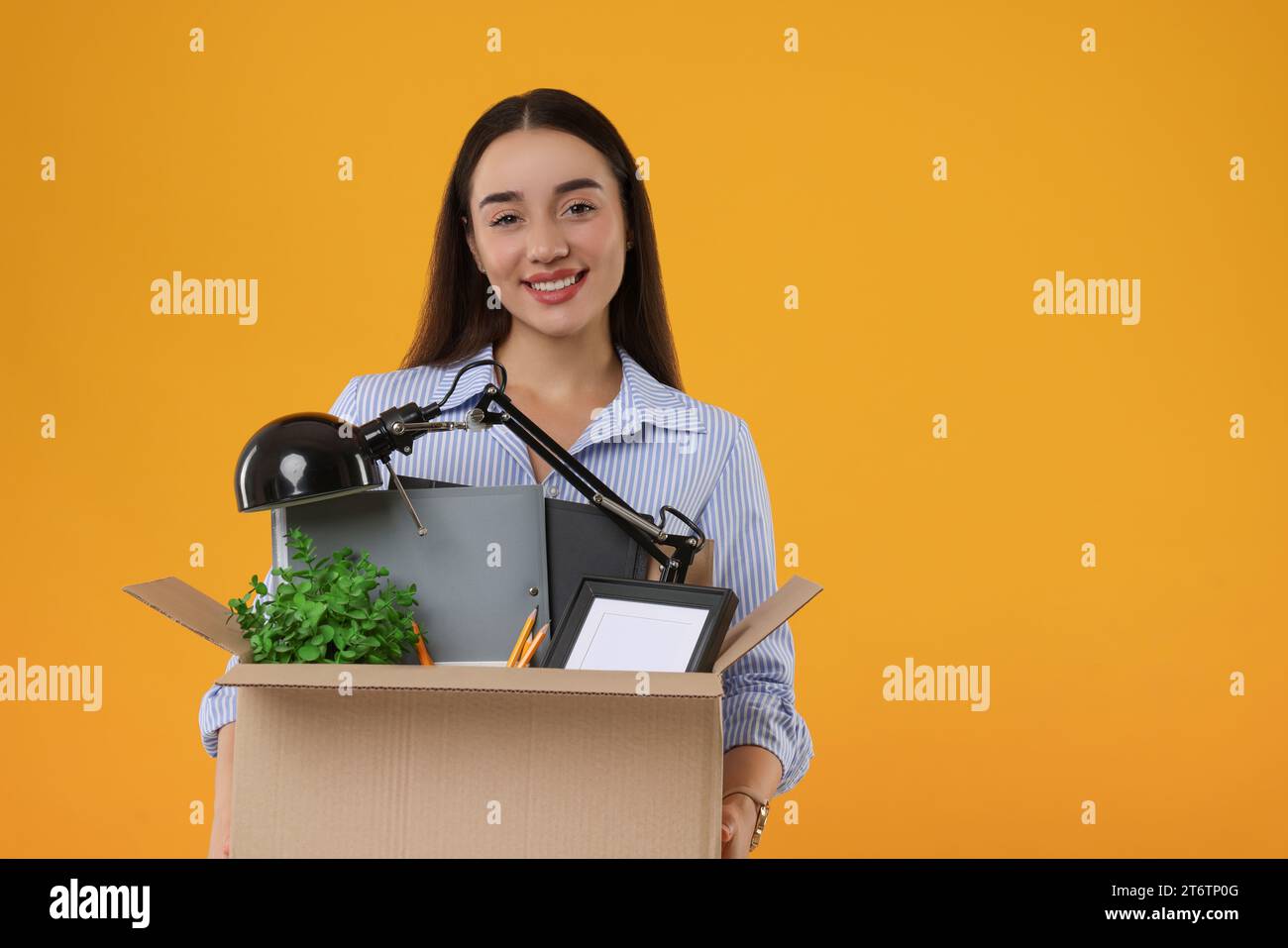 Happy unemployed woman holding box with personal office belongings on ...
