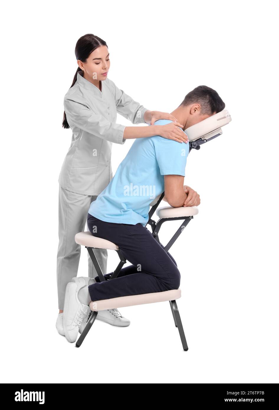 Man receiving massage in modern chair on white background Stock Photo ...