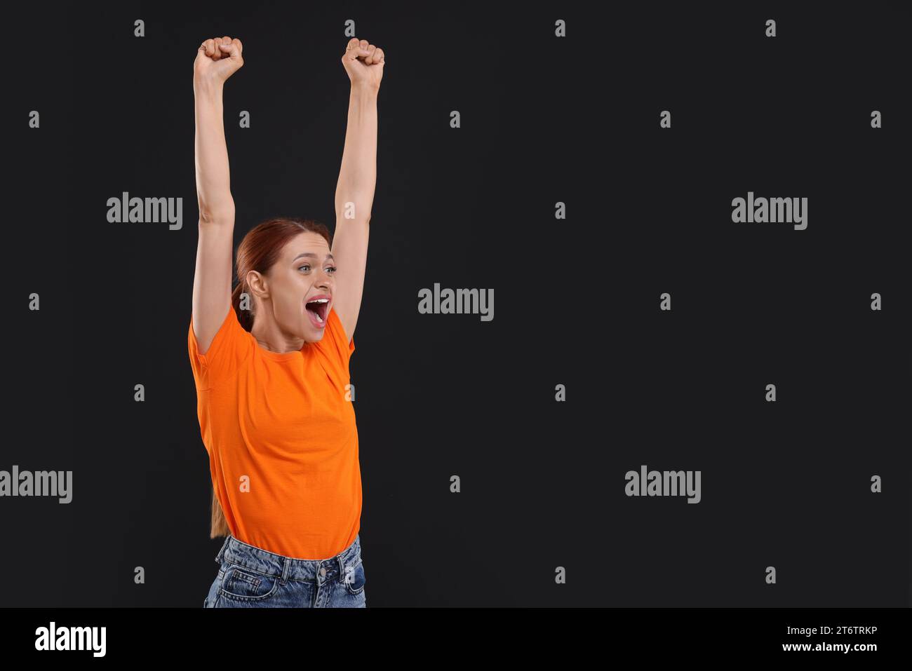 Emotional fan celebrating on black background, space for text Stock ...