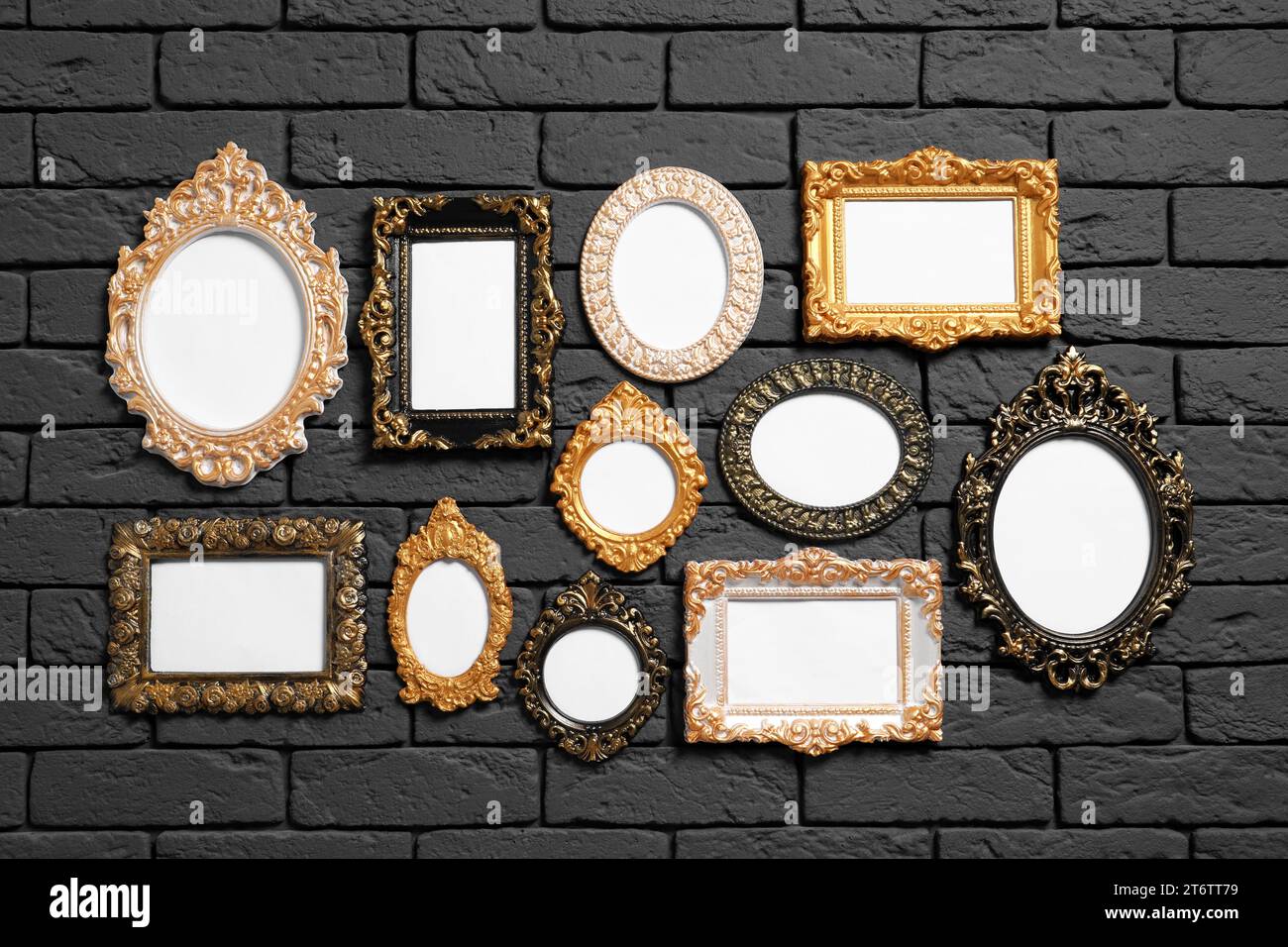 Empty vintage frames hanging on dark brick wall. Mockup for design Stock Photo - Alamy