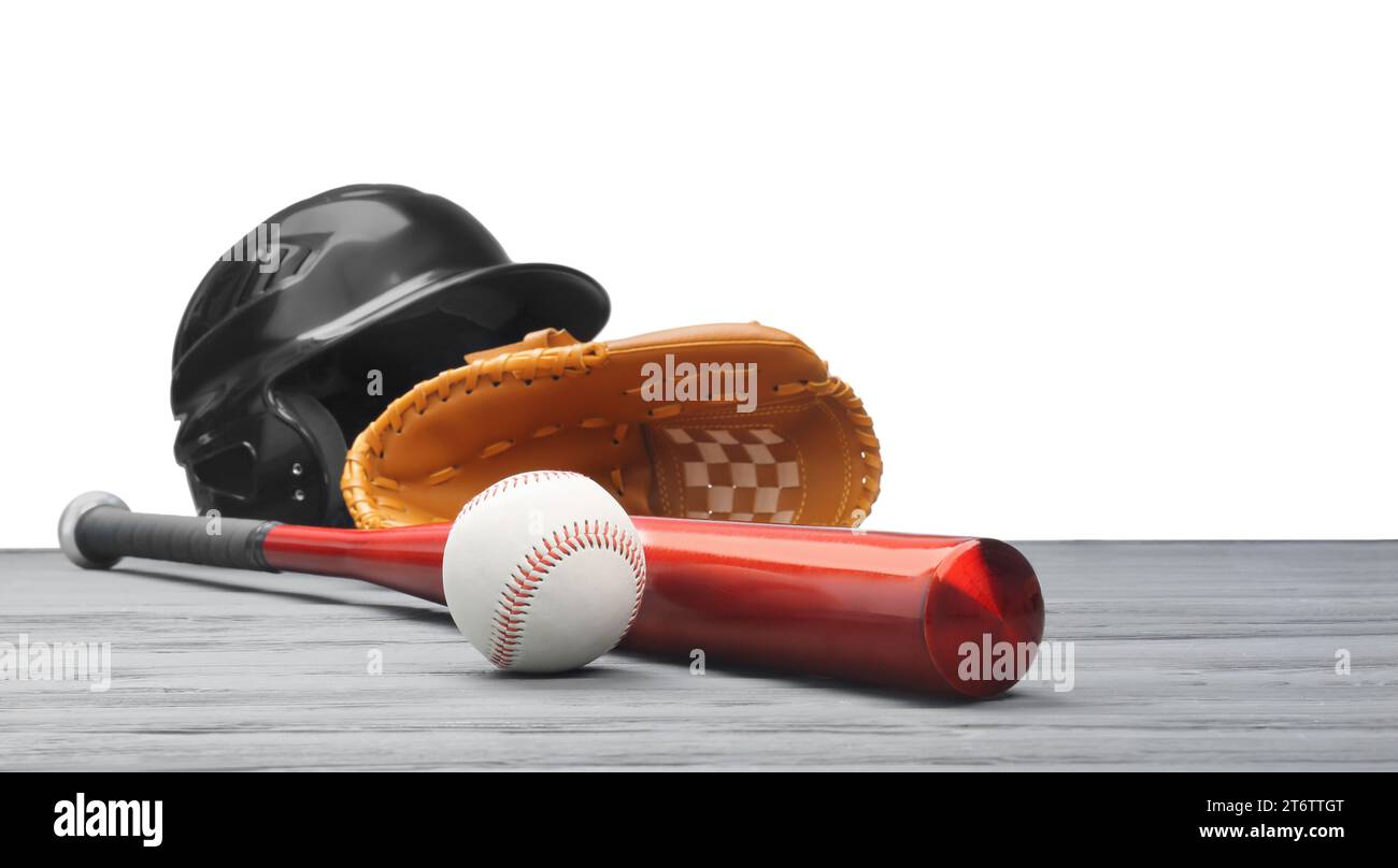 Baseball glove, bat, ball and batting helmet on grey wooden table ...
