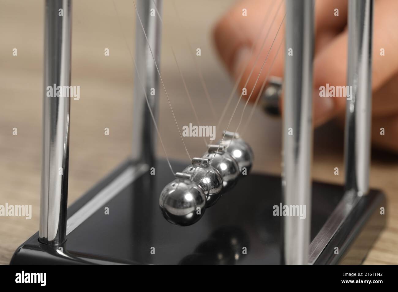 Newton's cradle and hand hi-res stock photography and images - Alamy