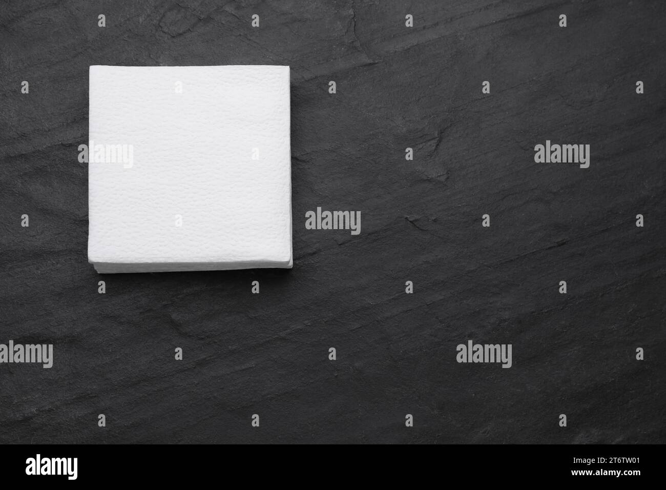 Stack of paper tissues on black table, top view. Space for text Stock ...