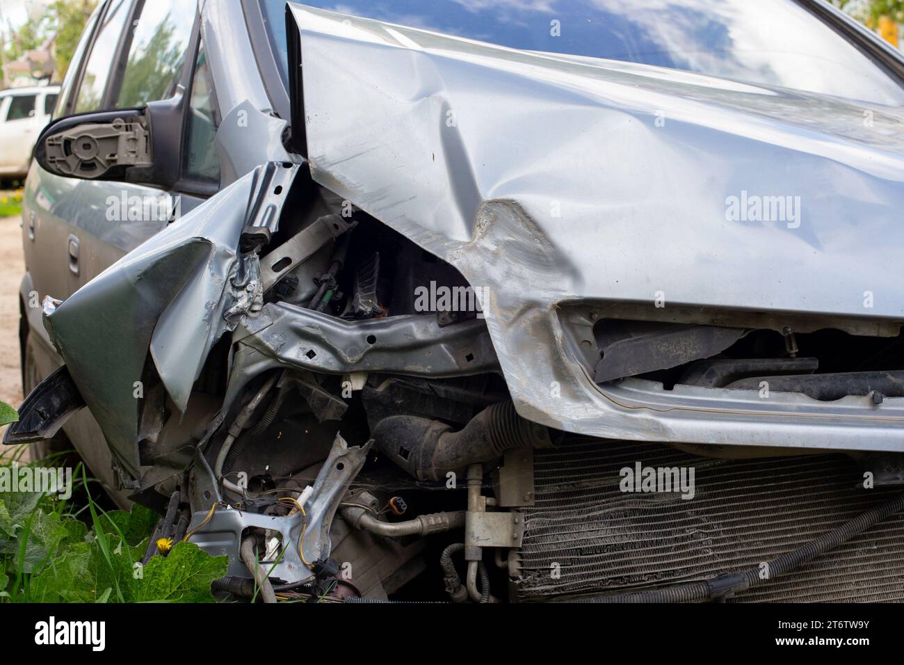 silver car nose smashed in an accident at day time Stock Photo - Alamy