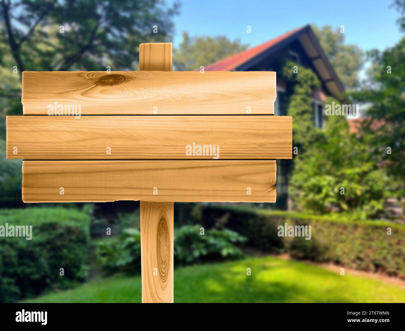 Empty wooden sign near beautiful house outdoors Stock Photo - Alamy