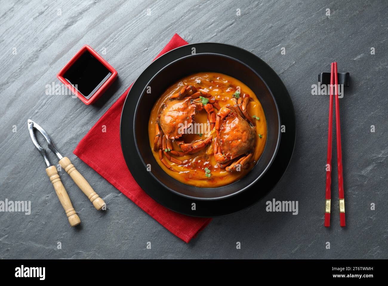 Delicious boiled crabs with sauce served on grey textured table, flat lay Stock Photo - Alamy