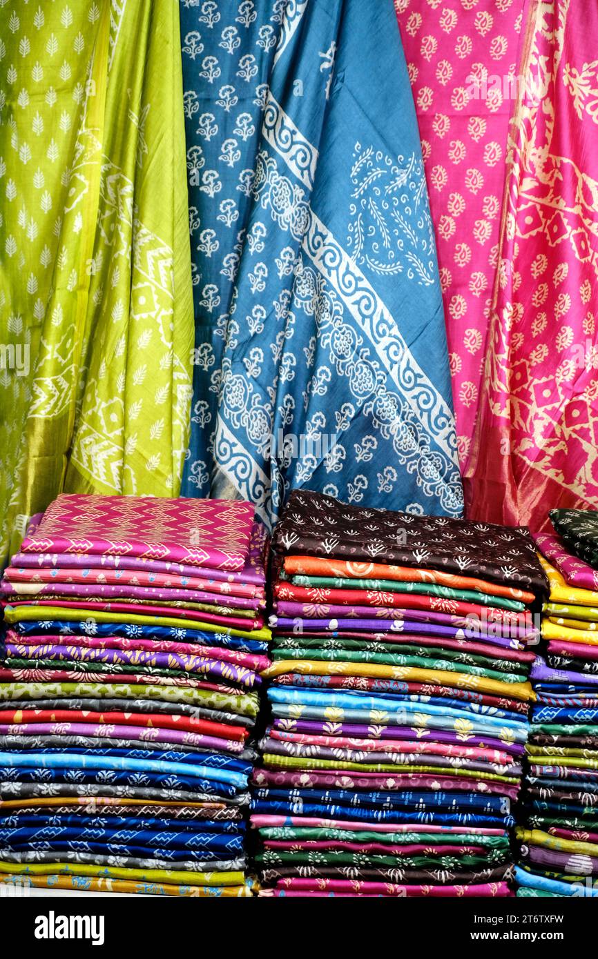 Fancy Indian sarees, Neatly stacked colorful silk saris in racks in a ...