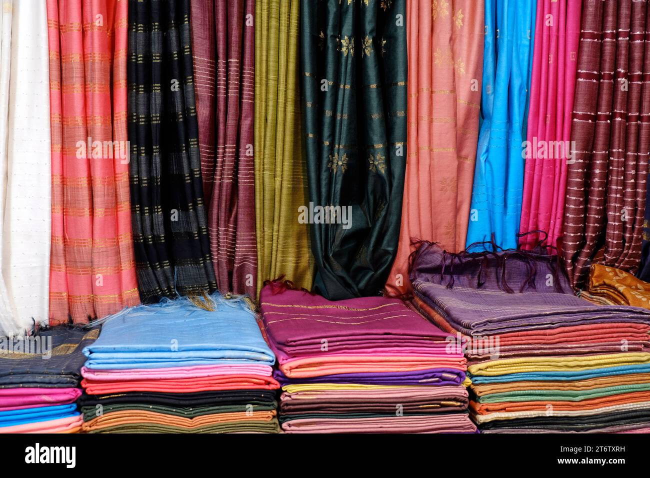 Fancy Indian sarees, Neatly stacked colorful silk saris in racks in a ...