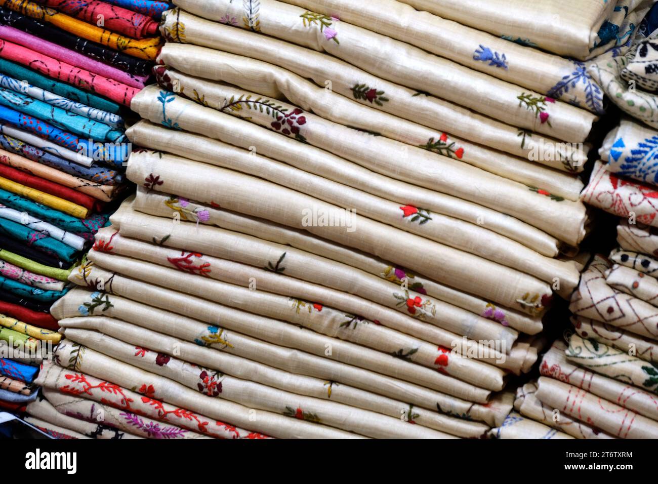 Fancy Indian sarees, Neatly stacked colorful silk saris in racks in a ...