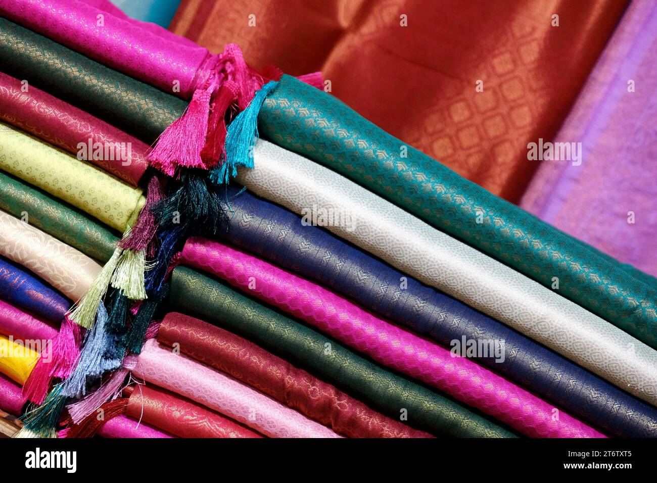 Fancy Indian sarees, Neatly stacked colorful silk saris in racks in a ...