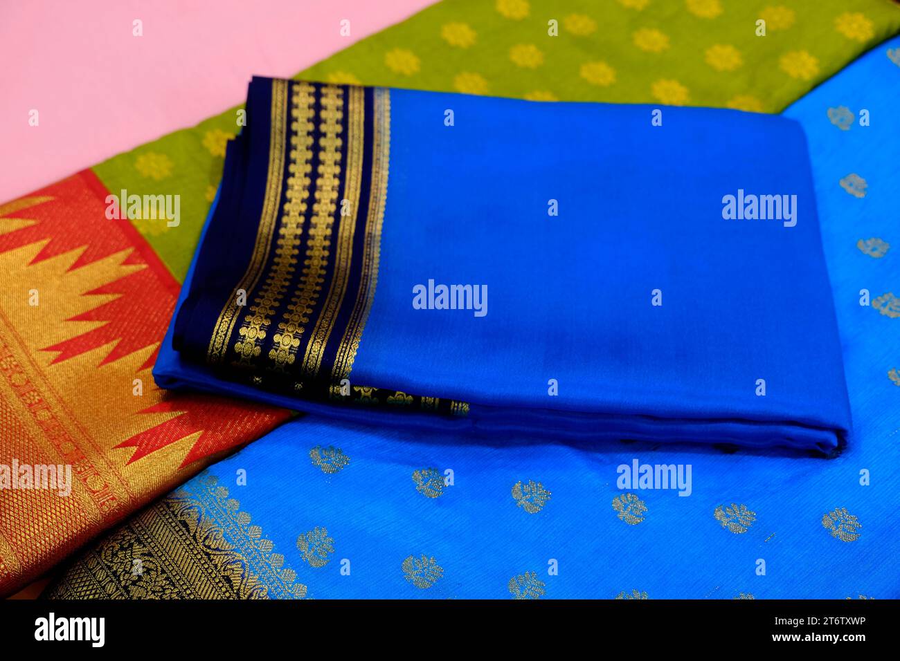 Fancy Indian sarees, Neatly stacked colorful silk saris in racks in a ...