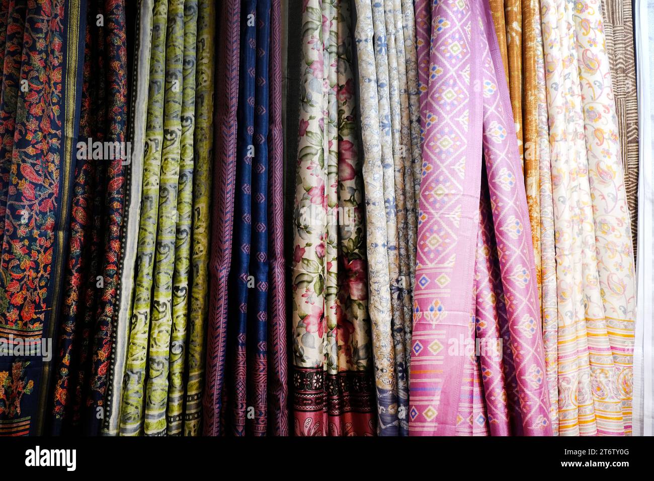 Fancy Indian sarees, Neatly stacked colorful silk saris in racks in a ...