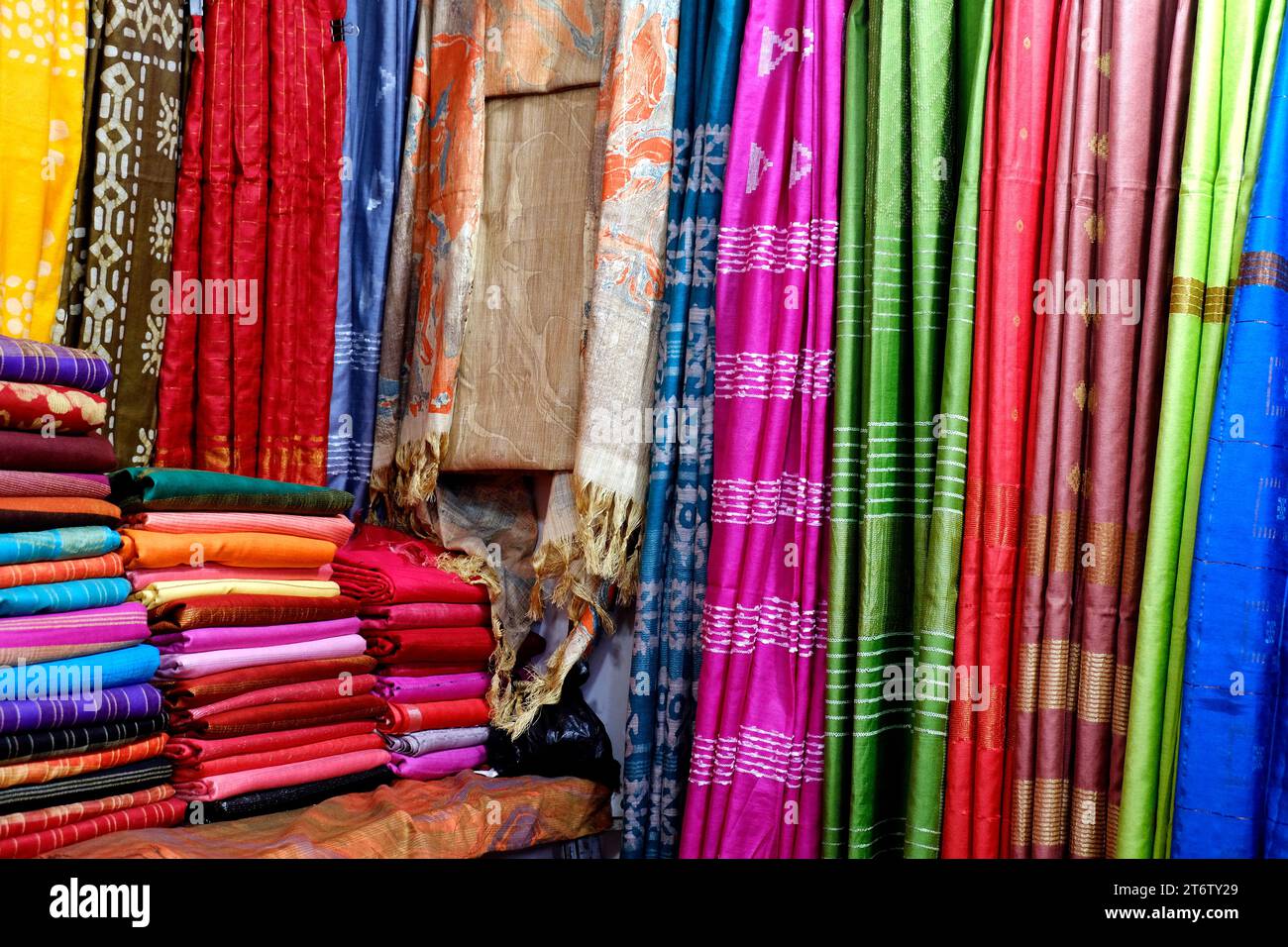 Fancy Indian sarees, Neatly stacked colorful silk saris in racks in a ...