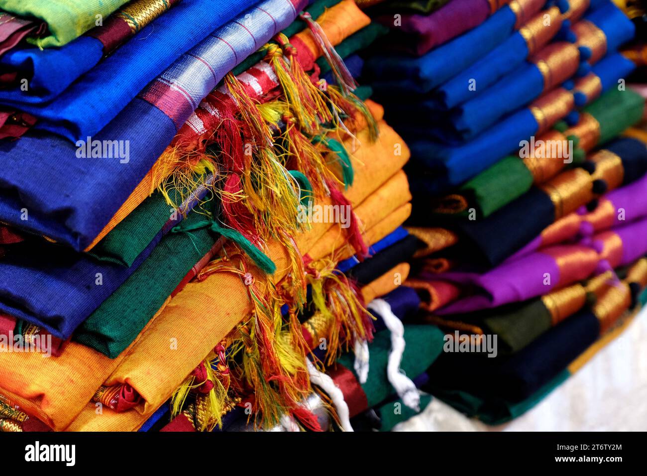 Fancy Indian sarees, Neatly stacked colorful silk saris in racks in a ...