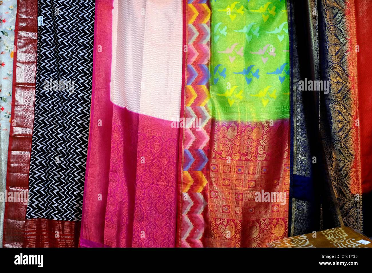 Fancy Indian sarees, Neatly stacked colorful silk saris in racks in a ...