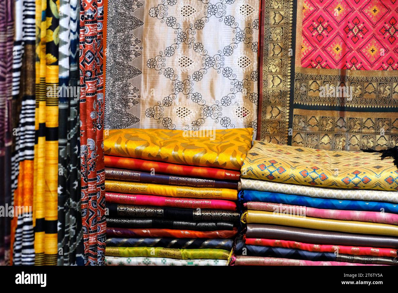 Fancy Indian sarees, Neatly stacked colorful silk saris in racks in a ...