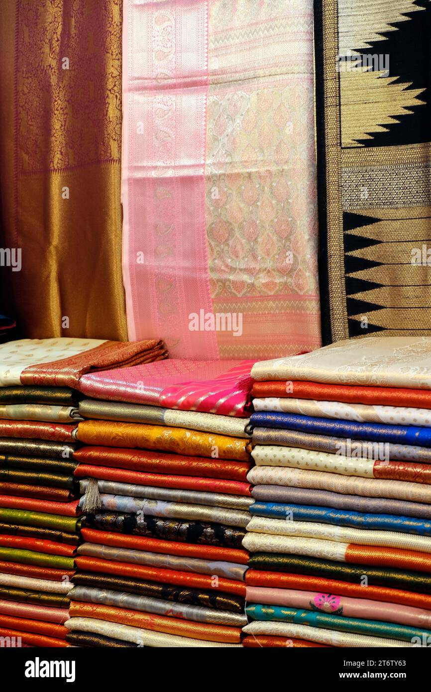 Fancy Indian sarees, Neatly stacked colorful silk saris in racks in a ...