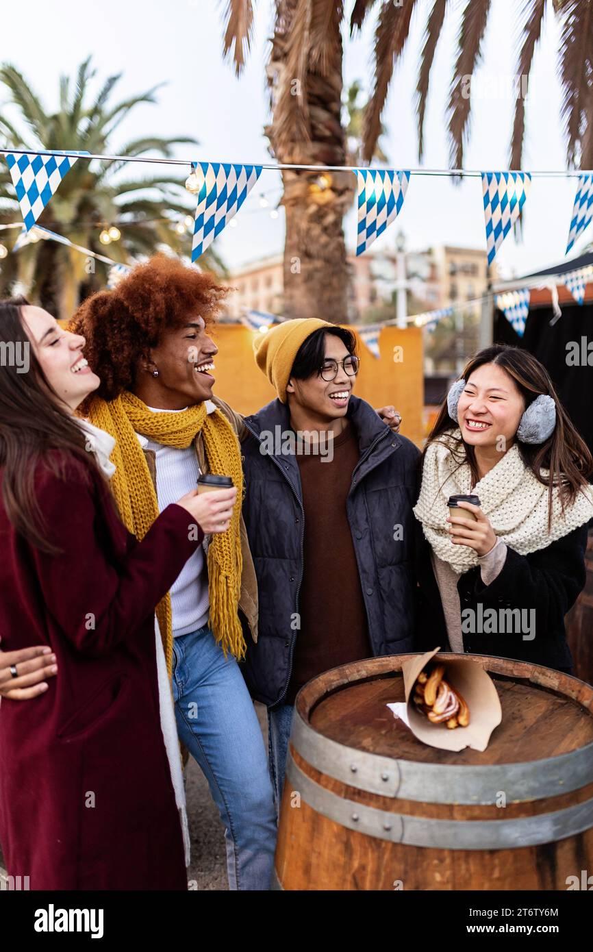Young group of diverse people in winter clothes having fun on christmas ...