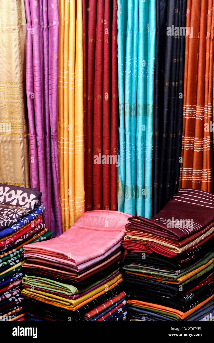 Fancy Indian sarees, Neatly stacked colorful silk saris in racks in a ...