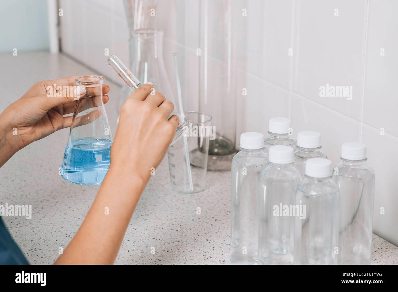 Women's hands in the laboratory examines the quality of water with a ...