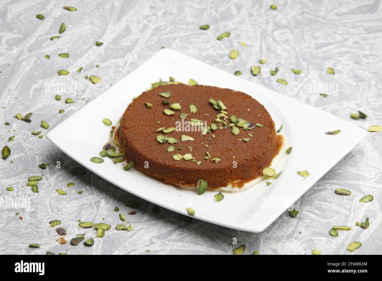 A delicious-looking, brown-colored pudding topped with pistachio and ...