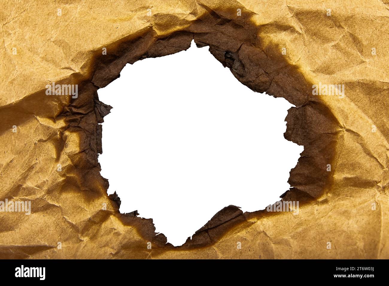 Burnt hole in yellow paper. Burnt paper Stock Photo - Alamy