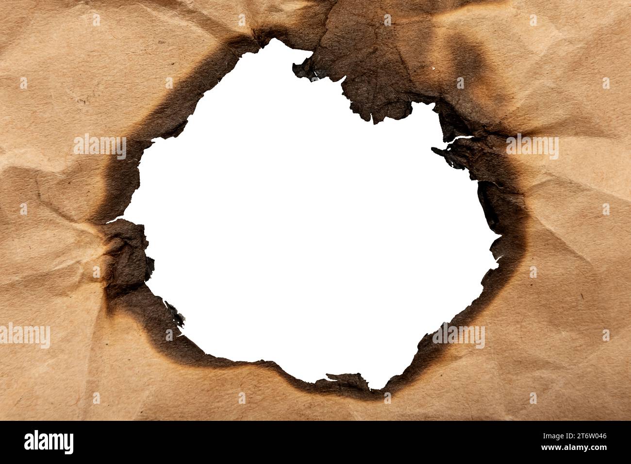 Burnt hole in yellow paper. Burnt paper Stock Photo - Alamy