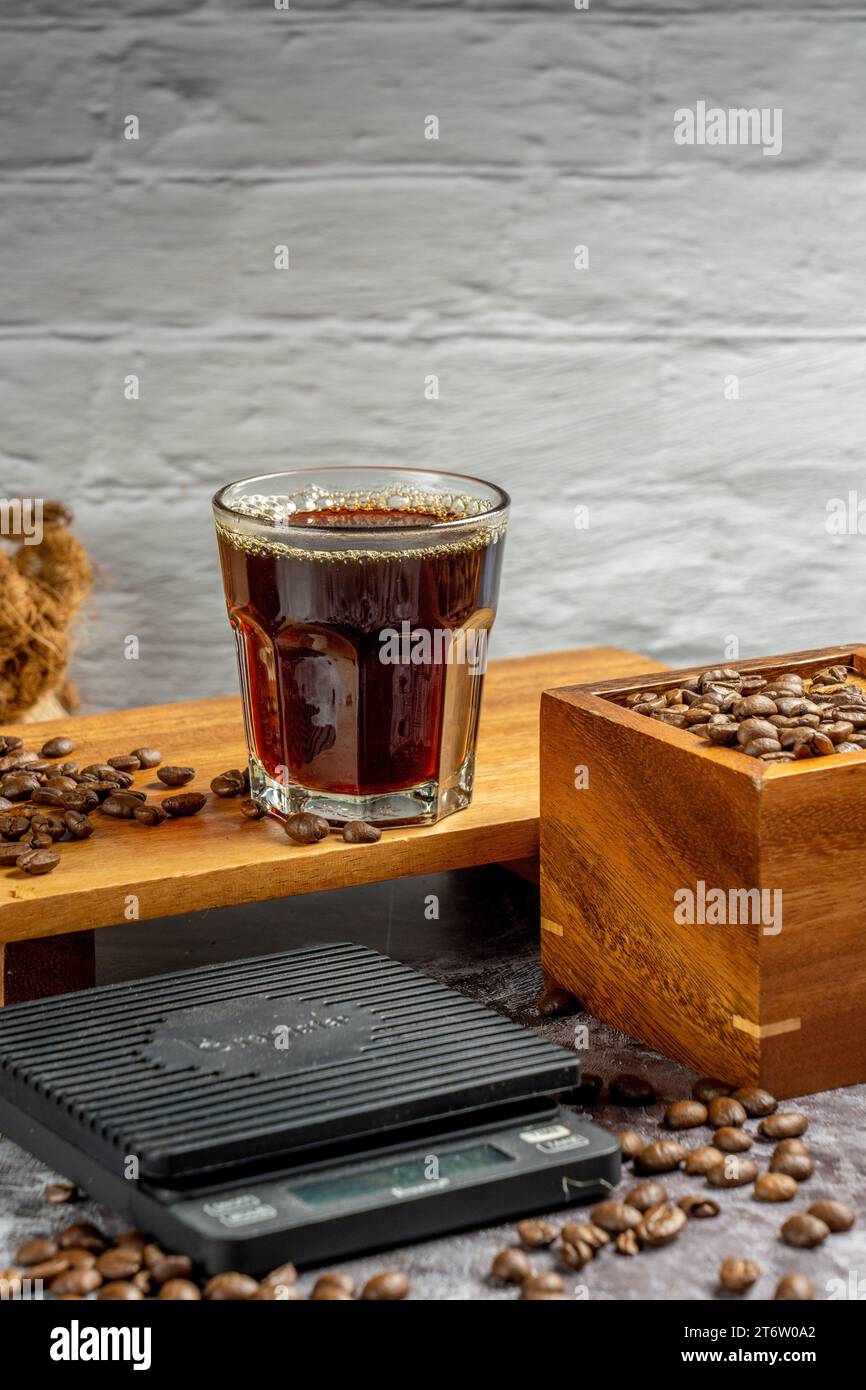 A white ceramic coffee cup is placed beside a toaster toasting a slice ...