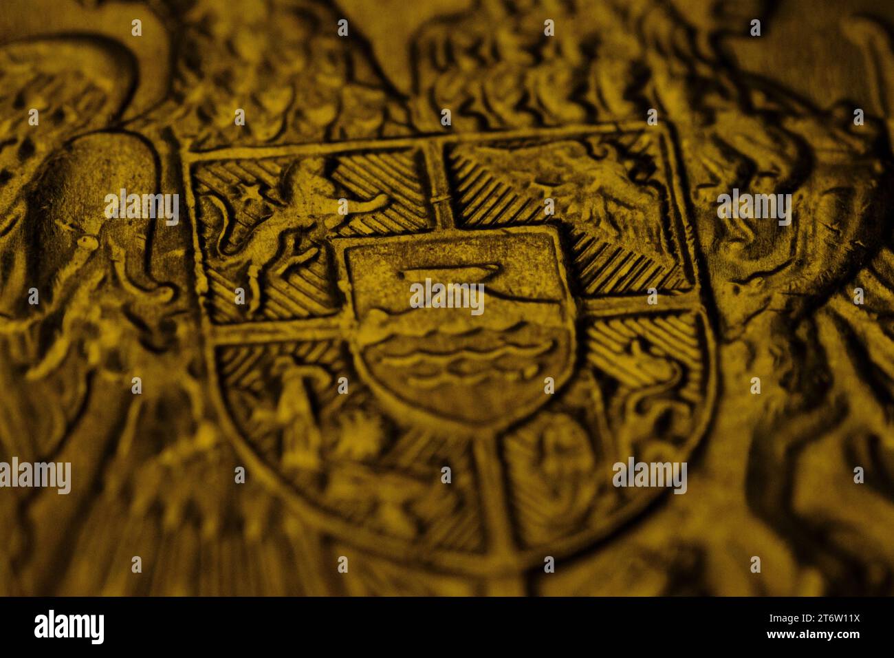 A stunning gold-colored coat of arms featuring a powerful lion and ...