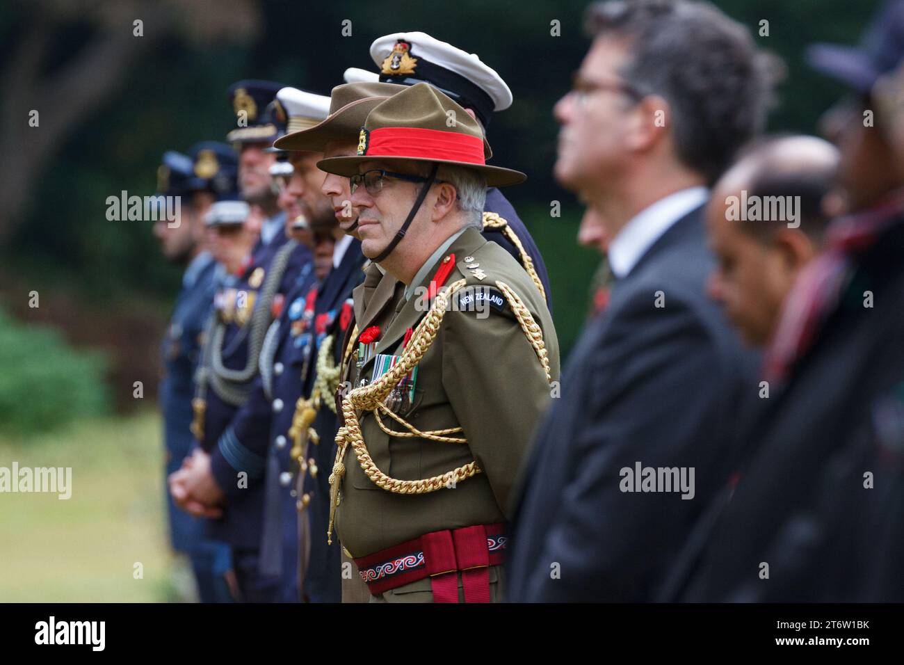 Men in military uniform line up with dignitaries during the Remembrance ...