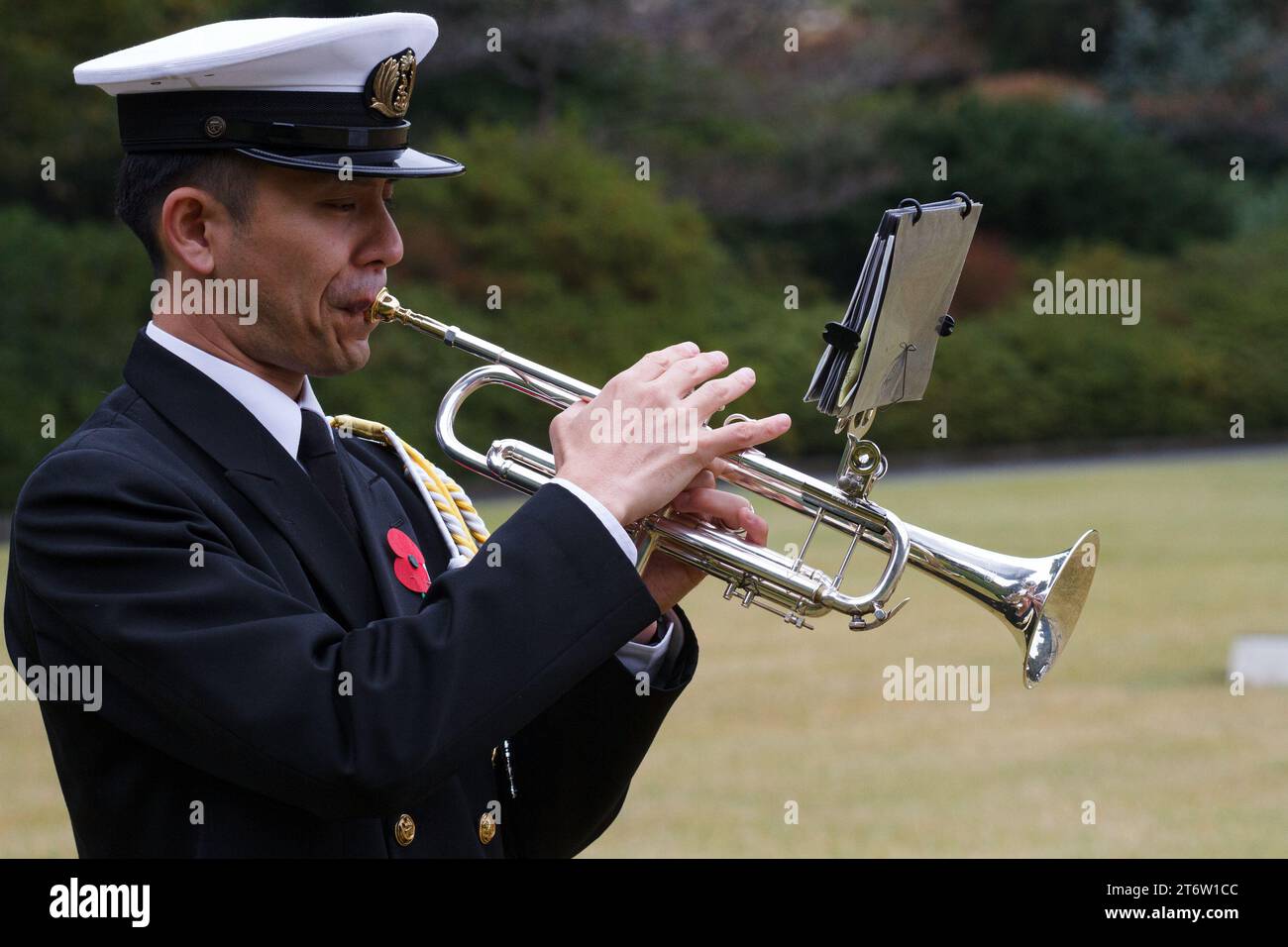 Bugler petty officer 2nd Class Shohei Yamada plays the Last Post during ...