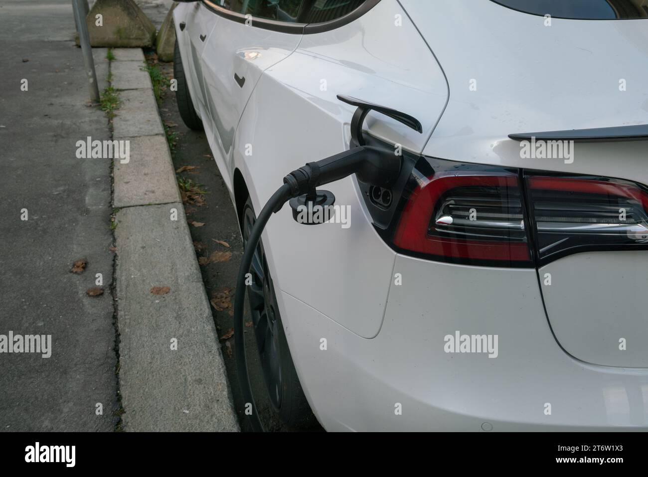 electric car charging, plug in to draw energy in the dedicated car park ...